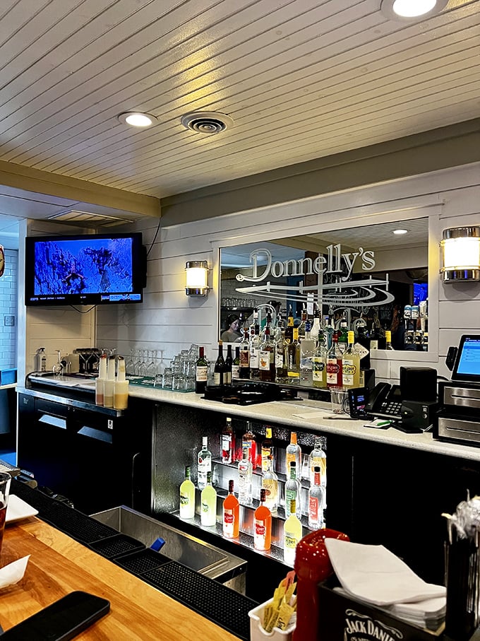 The bar area gleams with promise – cold drinks, good company, and that Donnelly's sign reflecting in the mirror.