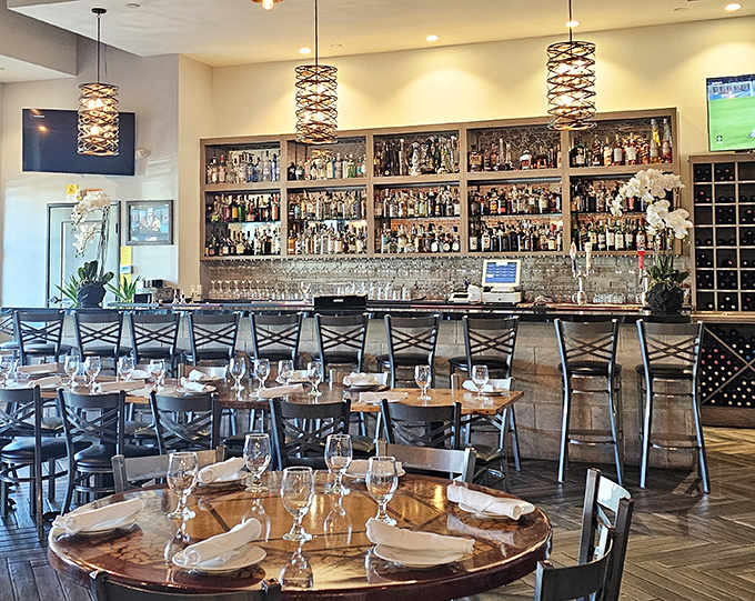 The bar area doesn't just serve drinks—it showcases them like liquid art, backed by an impressive collection that promises adventures by the glass.