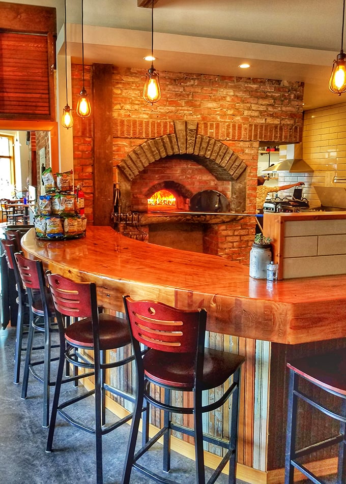 The wood-fired pizza oven and live-edge counter create a rustic elegance that matches the quality of everything they serve.