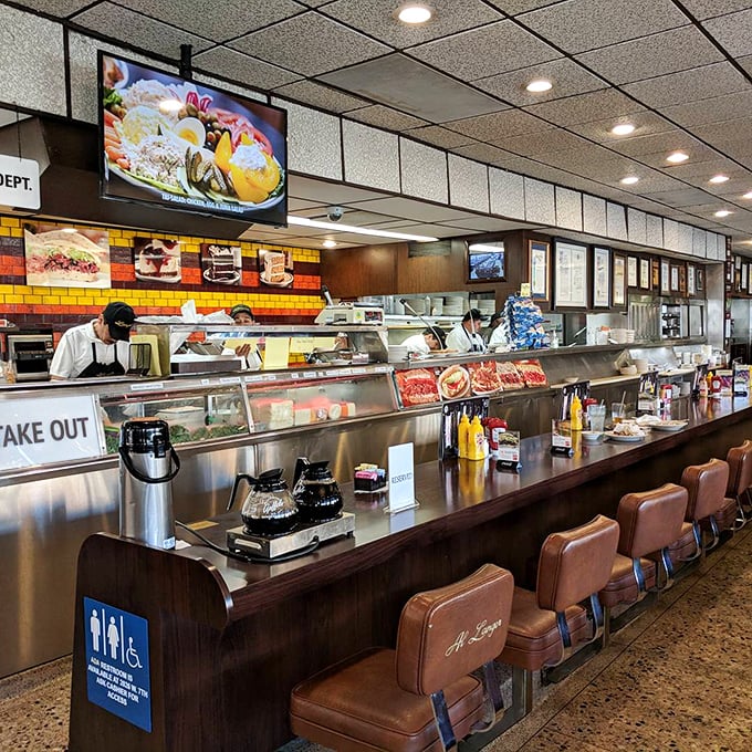 The counter where sandwich magic happens—like watching Olympic athletes, except the sport is pastrami slicing.