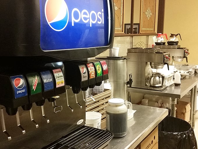 The humble beverage station—where coffee is always brewing and the soda machine stands ready to fulfill its fizzy promises without judgment.