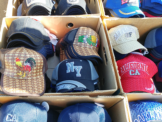 Baseball caps stuffed into boxes showcase everything from rooster logos to California pride for covering heads and showing personality.