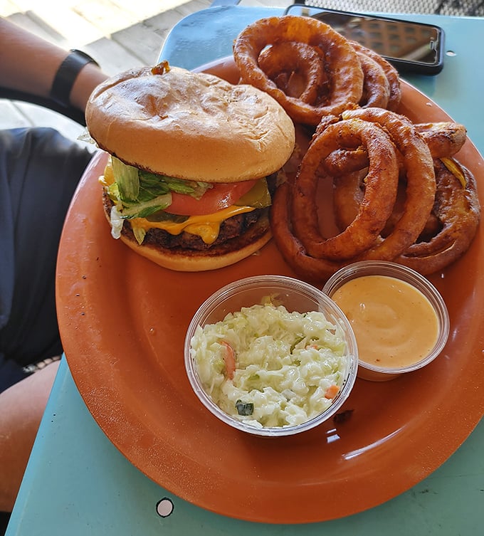 The classic American cheeseburger meets its match with those spectacular onion rings—a duo that proves sometimes the simplest pleasures are the most satisfying.