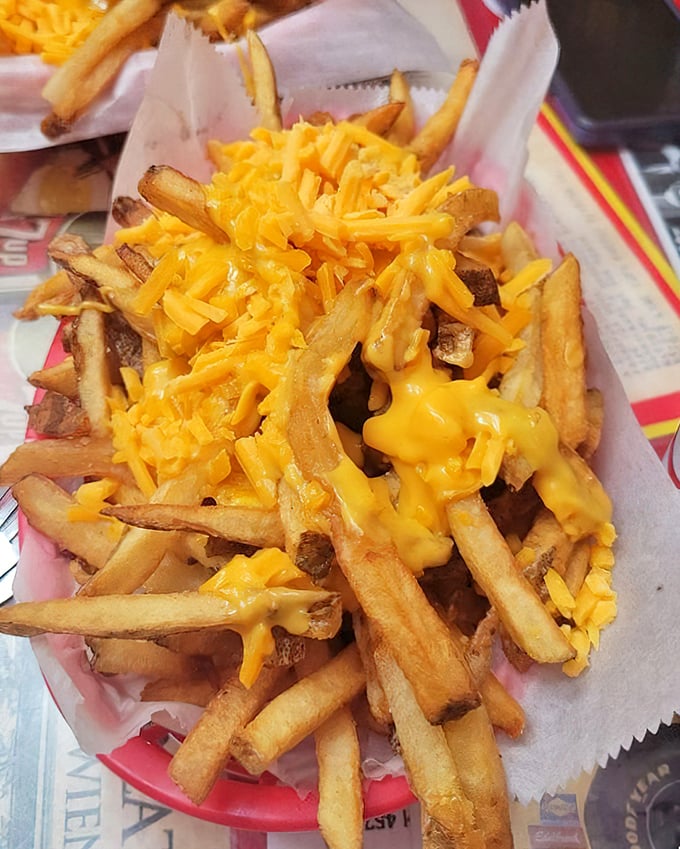 Cheese fries that make you want to write poetry—golden, hand-cut potatoes embraced by a blanket of melted cheddar that stretches with each bite.
