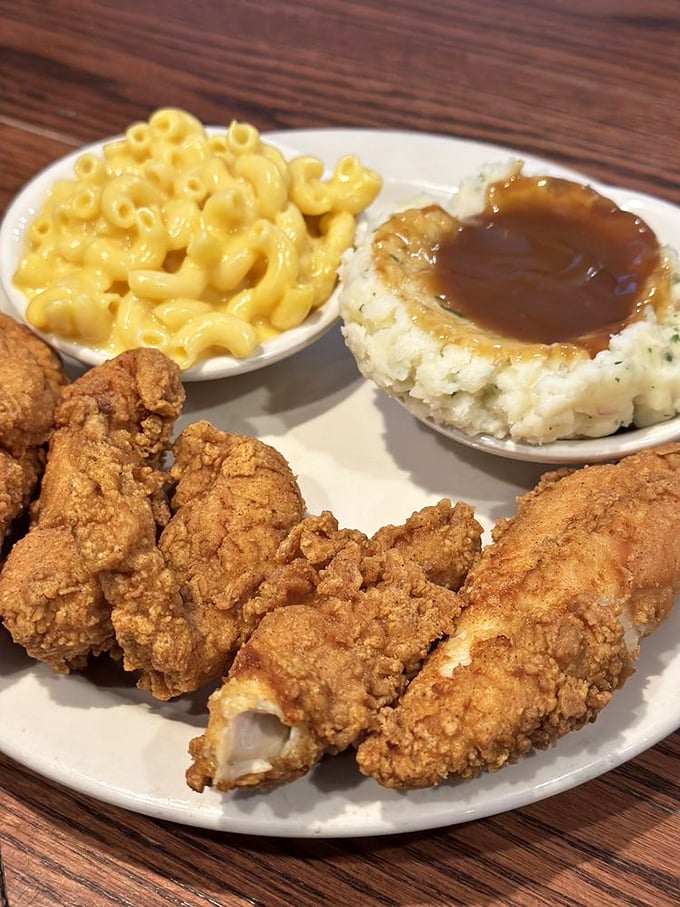 Chicken tenders with that perfect golden-brown exterior, mac and cheese that's actually cheesy, and mashed potatoes with gravy—comfort food's greatest hits album.