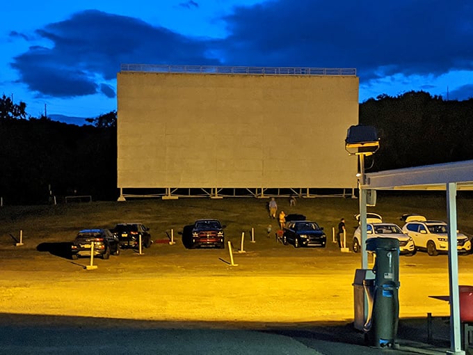 Under the watchful glow of security lights, cars gather like moths to a flame—drawn by the promise of stories told larger than life.