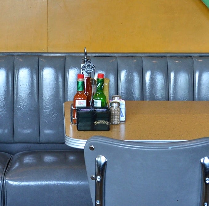 That condiment caddy is the unsung hero of any great deli experience—hot sauce, ketchup, and mustard standing at attention, ready for duty.