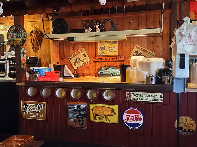 The counter where barbecue dreams come true, adorned with vintage signs that aren't manufactured nostalgia—they're badges of honor earned through years of smoke.
