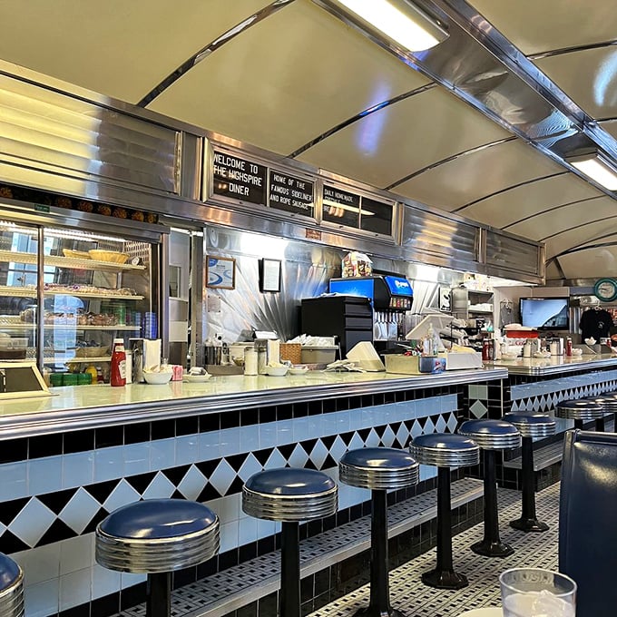 The counter – where solo diners find community, regulars claim their territory, and the coffee flows as freely as the conversation.