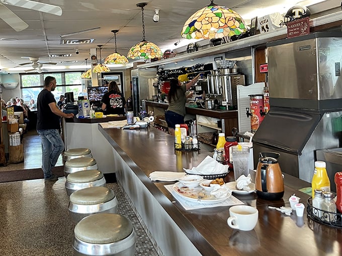 The counter area showcases beautiful stained glass pendant lights – unexpected touches of elegance in this unpretentious eatery.