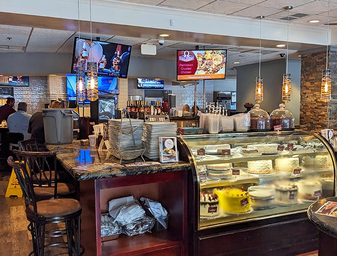 The dessert case—where good intentions go to surrender. That marble countertop has witnessed countless "just a small slice" negotiations.