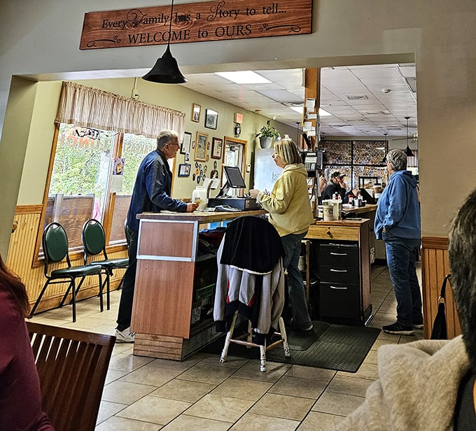 Where everybody knows your name – or will by your second visit. The welcoming counter at Country Diner, where breakfast dreams come true beneath that charming wooden sign.