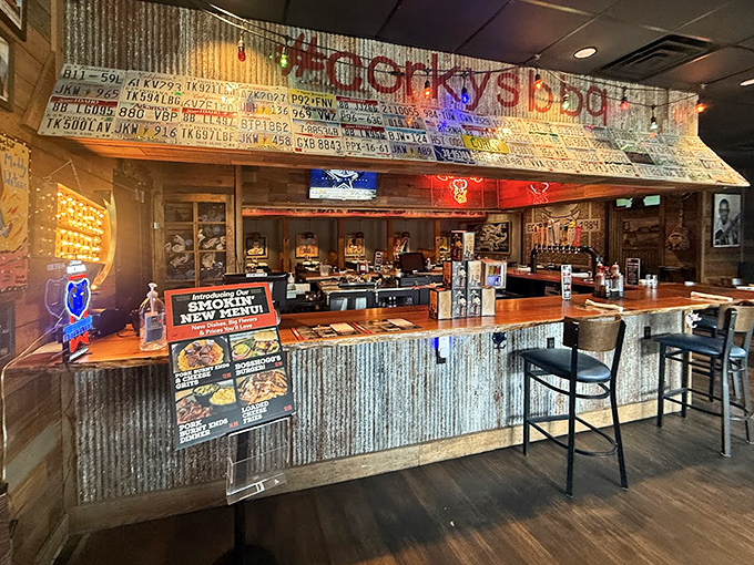 The counter where barbecue dreams are born—corrugated metal, license plates, and the promise of smoky treasures just beyond.
