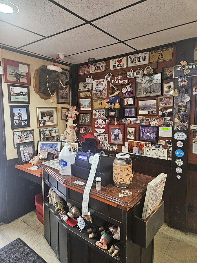 The check-in counter doubles as a museum of local history—each photo and license plate telling stories as rich as the barbecue.