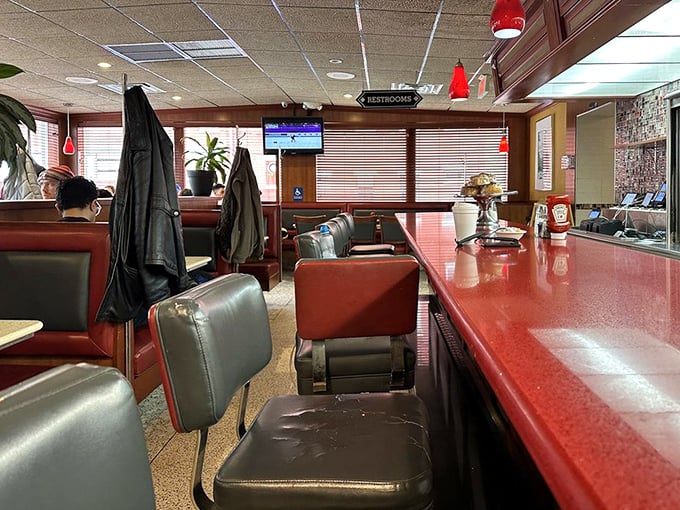 The counter seating—where solo diners become part of the diner family and the coffee refills come with a side of local wisdom.