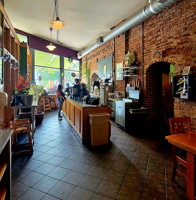 The counter area with exposed brick feels like the kitchen of that cool friend who actually knows how to cook and always has fresh flowers.