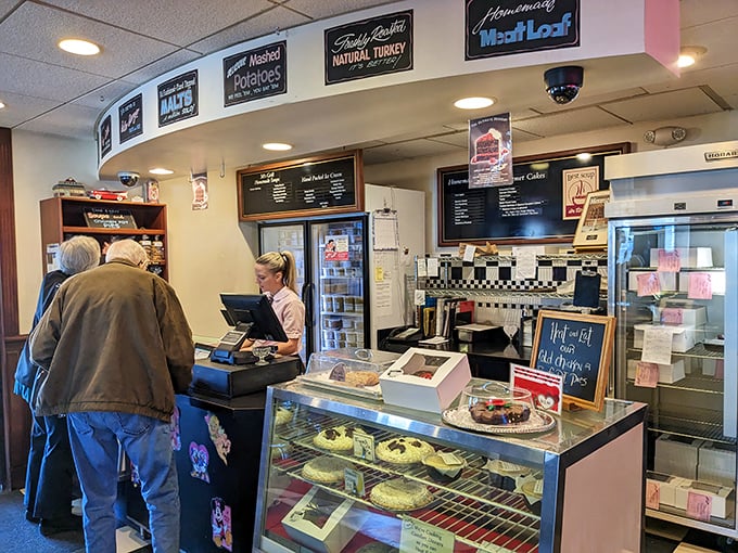 The dessert counter—where willpower goes to die. That sign might as well read "Abandon diet, all ye who enter here."