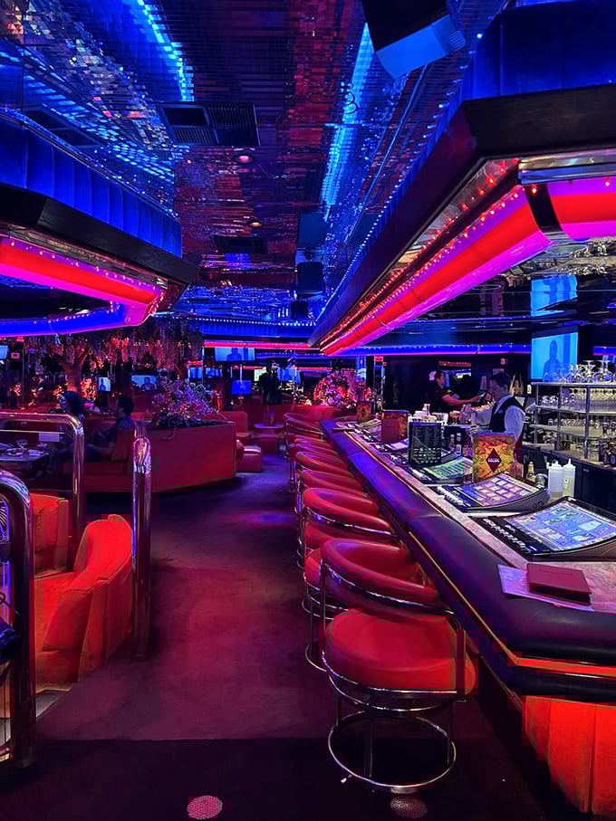 Counter seating offers front-row views of the culinary theater, where breakfast magic happens under psychedelic lighting that never gets old.