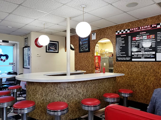 The counter view reveals the stage where burger magic happens—simple ingredients transformed into legendary meals under those iconic globe lights.