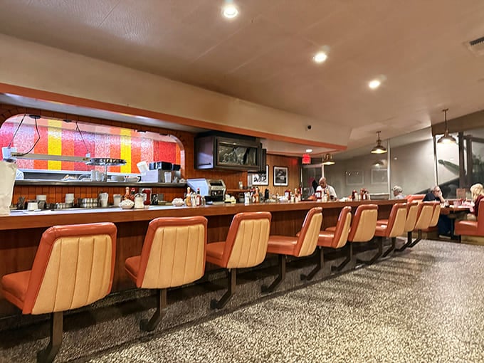 The counter—where solo diners find community, servers perform their coffee-pouring ballet, and the short-order symphony plays on in perfect harmony.