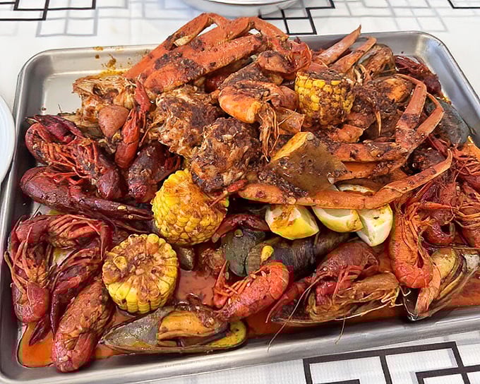 The seafood boil in all its glory—a magnificent mess of crawfish, corn, and potatoes. Spice-crusted crustaceans demanding to be devoured.