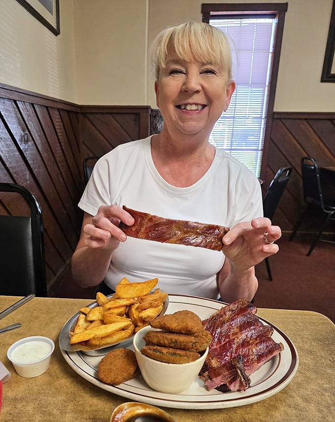 The image shows a diner enjoying their meal with obvious delight—the universal expression of barbecue happiness.
