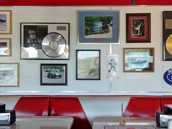 The wall of fame – records, photos, and memorabilia creating the perfect backdrop for your booth. Each frame tells a story from simpler times.