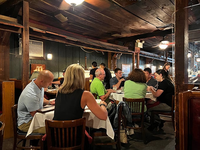 Diners nestled beneath rustic wooden beams, creating memories one seafood feast at a time in this intimate setting.