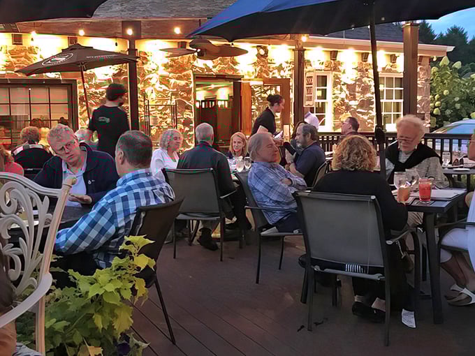 The outdoor patio at dusk—where summer evenings stretch into memory-making moments and strangers at nearby tables become temporary friends.