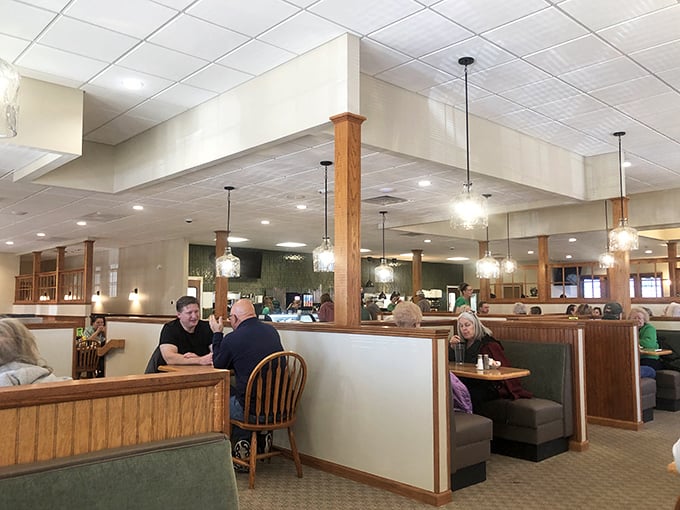 Modern pendant lighting meets classic booth seating – proving Busy Corner knows comfort never goes out of style, even when the decor gets updates.