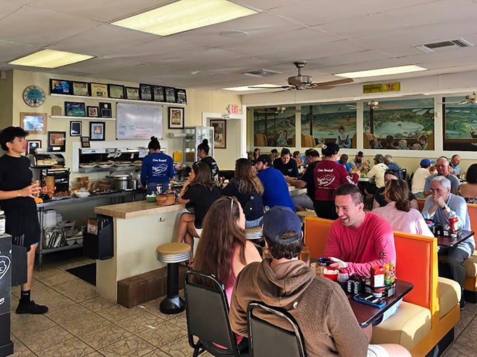 A bustling dining room where strangers become friends over coffee refills. The true Florida Keys experience happens between these booths.