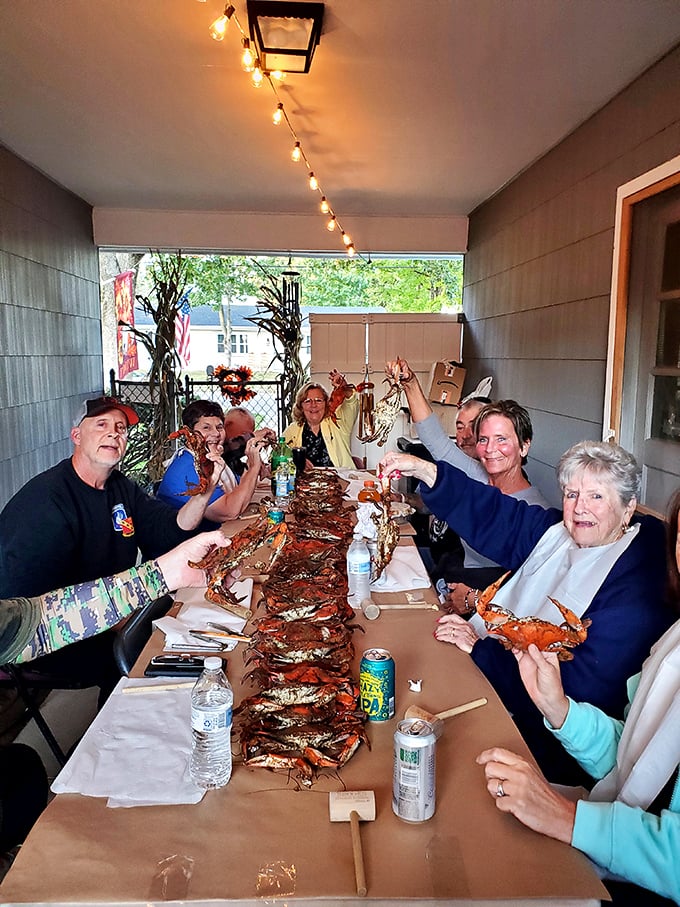 The ultimate Maryland social gathering—newspaper-covered tables, mallets in hand, and the shared joy of dismantling crabs piece by delicious piece.