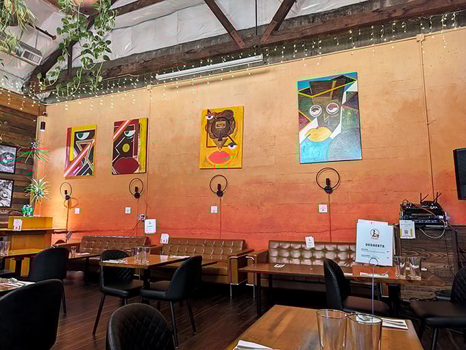 Colorful artwork against ombre walls creates a dining space that feels both gallery-cool and living-room comfortable.