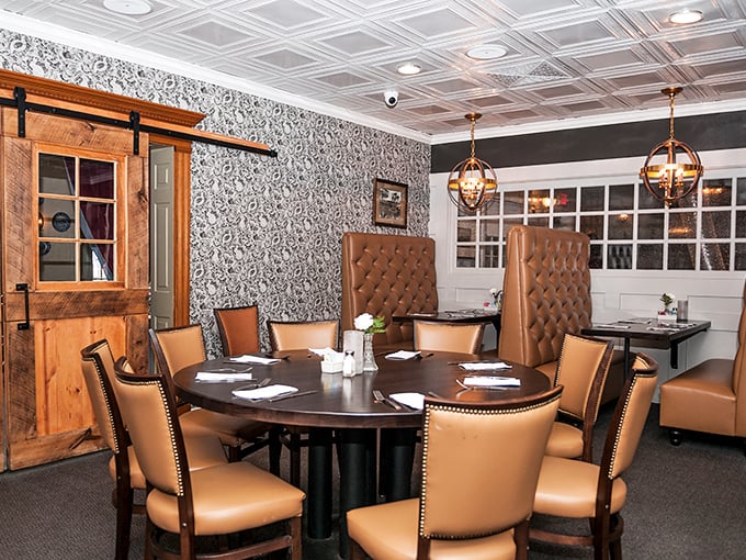 Private dining with high-backed leather booths and elegant wallpaper—where important decisions are made, like whether to order dessert. (Spoiler: always yes.) 