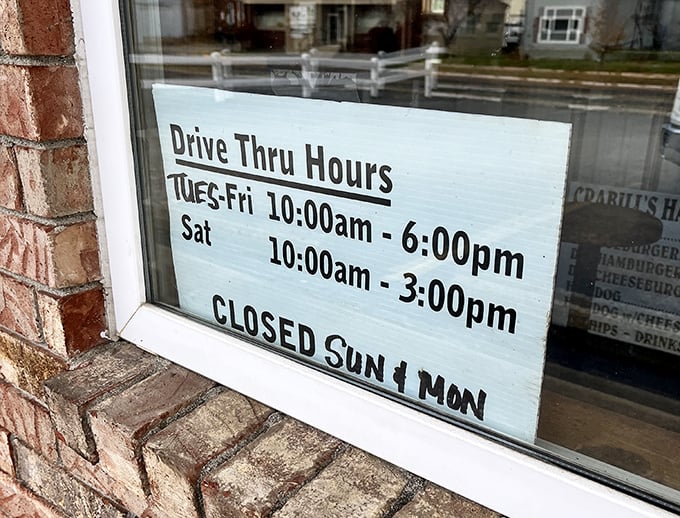 The window sign tells the story—this isn't a 24/7 operation because perfection requires rest, even for legendary burger joints.