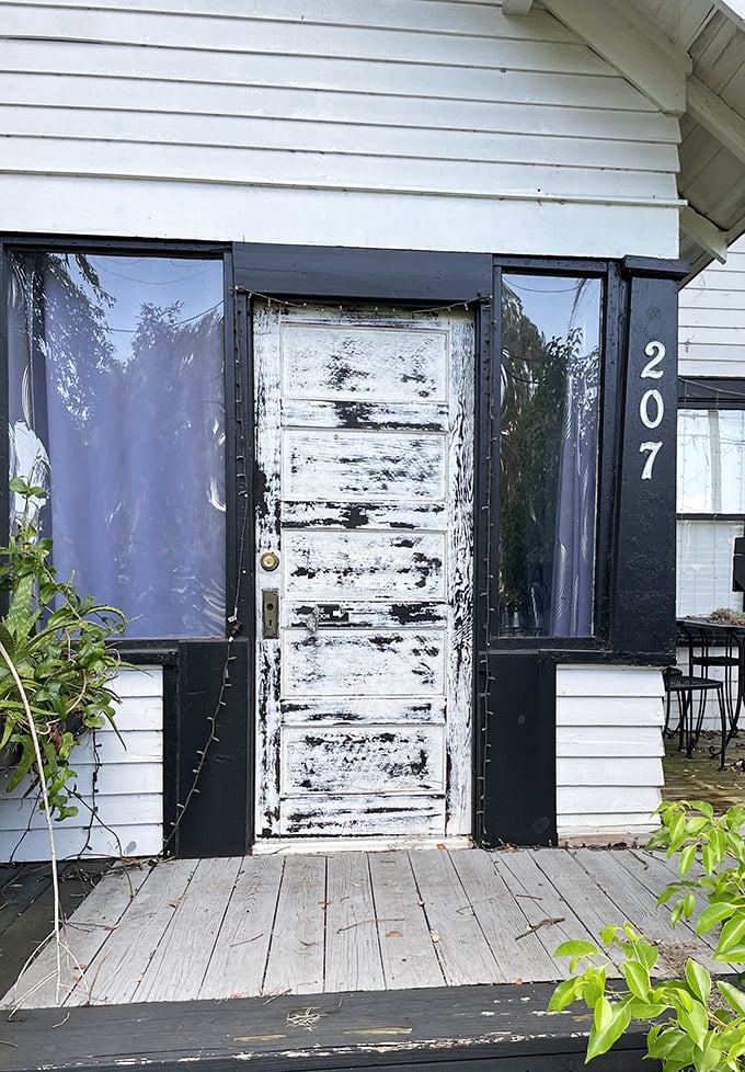That weathered white door isn't just an entrance – it's a portal to one of Florida's most delicious hidden treasures.
