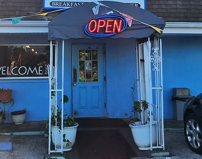 The welcoming entrance with its neon "OPEN" sign – like a lighthouse guiding hungry travelers to safe, delicious harbor.
