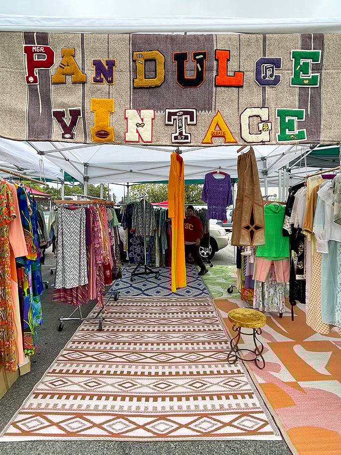 "Pan Dulce Vintage" displays its colorful wares beneath collegiate letters, where fashion archaeology meets academic nostalgia in perfect harmony.