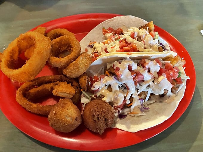 Fish tacos flanked by golden onion rings—a coastal combo that makes you wonder why you'd ever order anything else.
