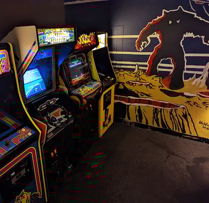 The arcade corner offers nostalgic entertainment while you wait for your pizza—Pac-Man never tasted anticipation this delicious.