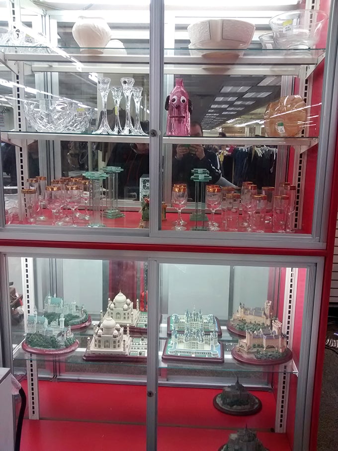 Crystal and collectibles gleam behind glass, miniature architectural wonders below—proof that one person's decluttering becomes another's discovered treasure.
