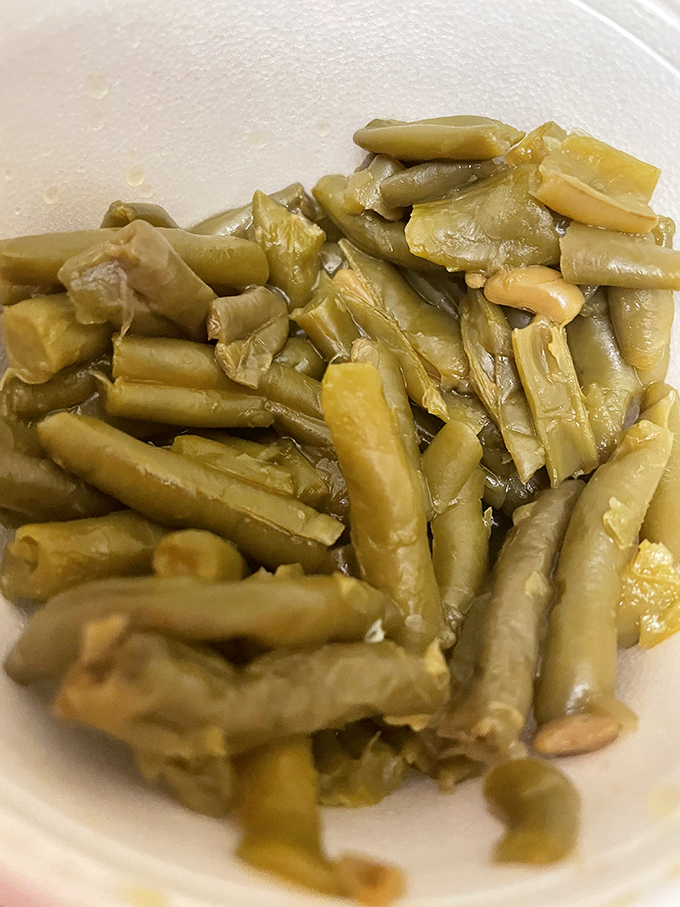 Green beans that have clearly been introduced to a ham hock. These aren't your cafeteria vegetables—they've lived a little and have stories to tell.
