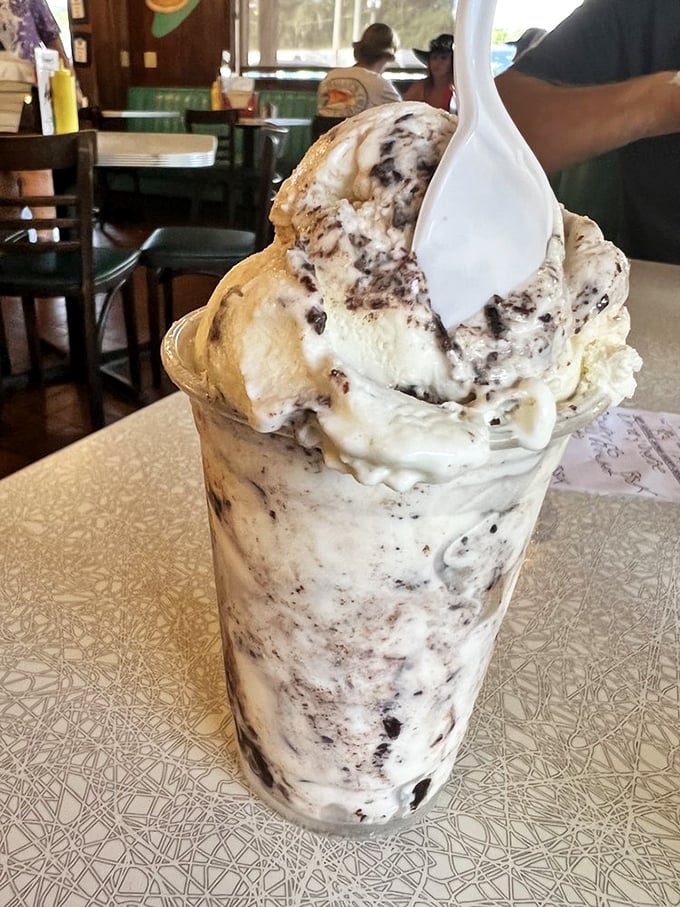 This cookies and cream milkshake isn't just dessert—it's a cup of happiness with a spoon standing at attention, ready for duty.