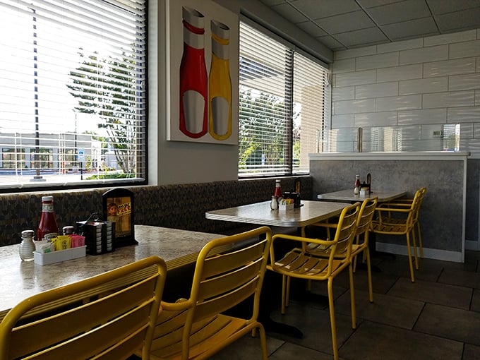 Retro meets functional with those bright yellow chairs and condiment caddies. Ketchup and mustard bottles—the unsung heroes of every great diner meal.