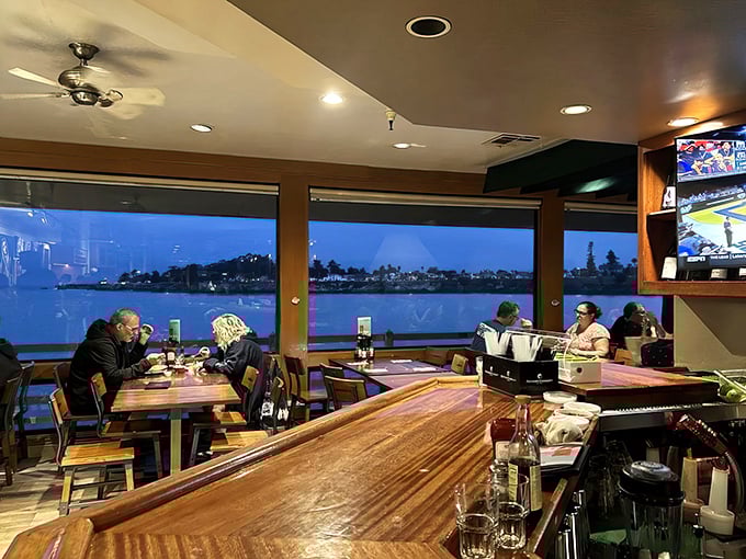 As twilight falls, the restaurant transforms into a cozy haven where ocean views compete with the comfort of good food and company.