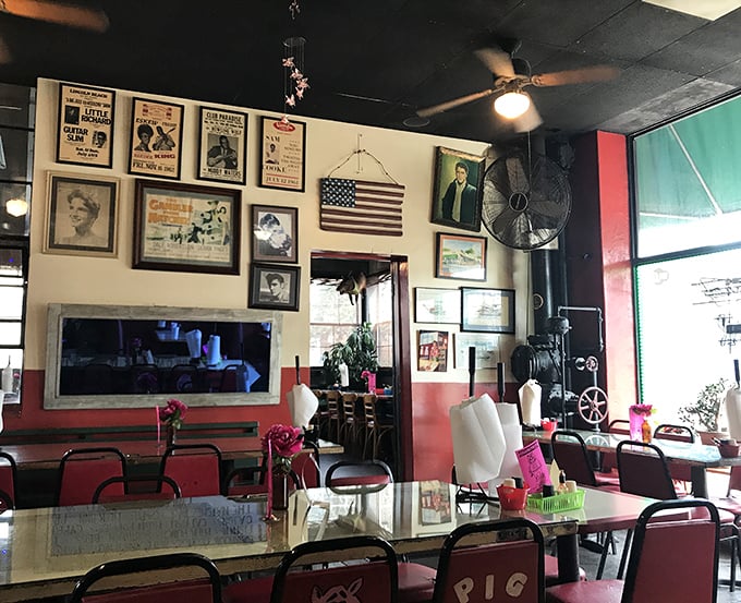 The walls tell stories of barbecue pilgrimages past, while ceiling fans gently circulate that intoxicating aroma of hickory smoke throughout the dining room.