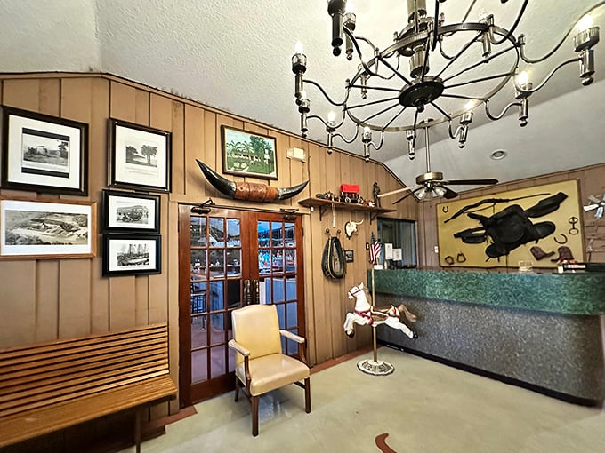 The reception area's wood paneling and vintage photos tell stories of Tampa's past. That longhorn on the wall isn't decoration—it's a warning to other cows.