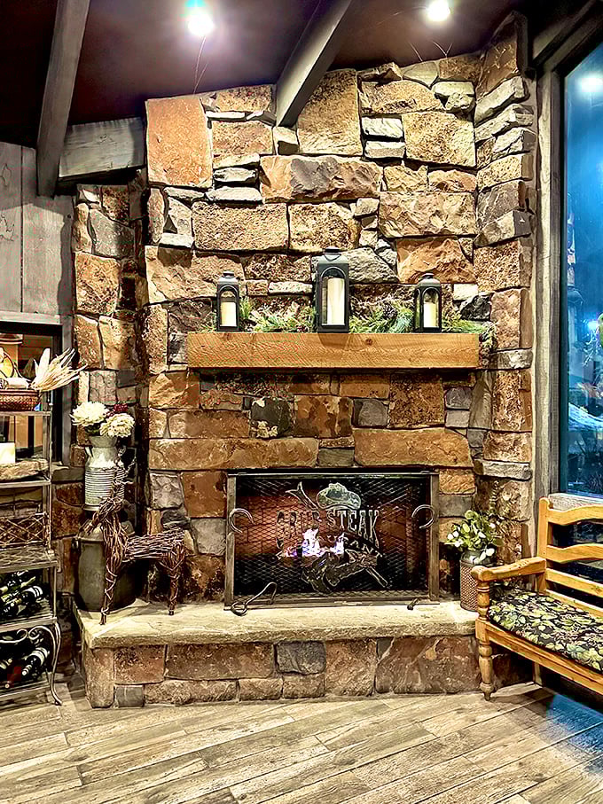 The stone fireplace isn't just decor—it's the beating heart of the restaurant, warming both the space and the spirits of winter-chilled diners.