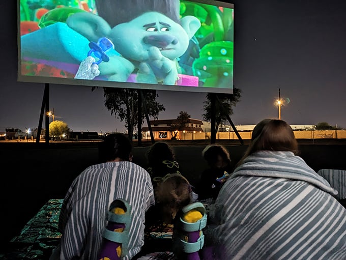 Little ones discover the magic of outdoor movies, where bedtime becomes negotiable and wonder fills the air.