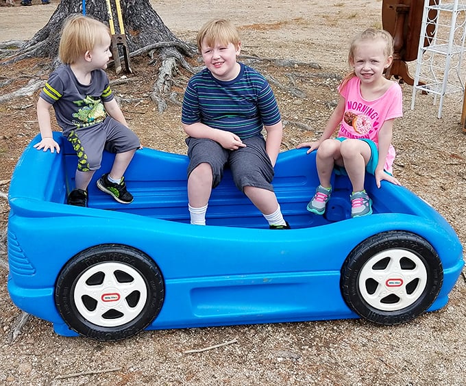 Even kids find joy here, taking breaks from shopping on oversized toy cars between vendor booth explorations.